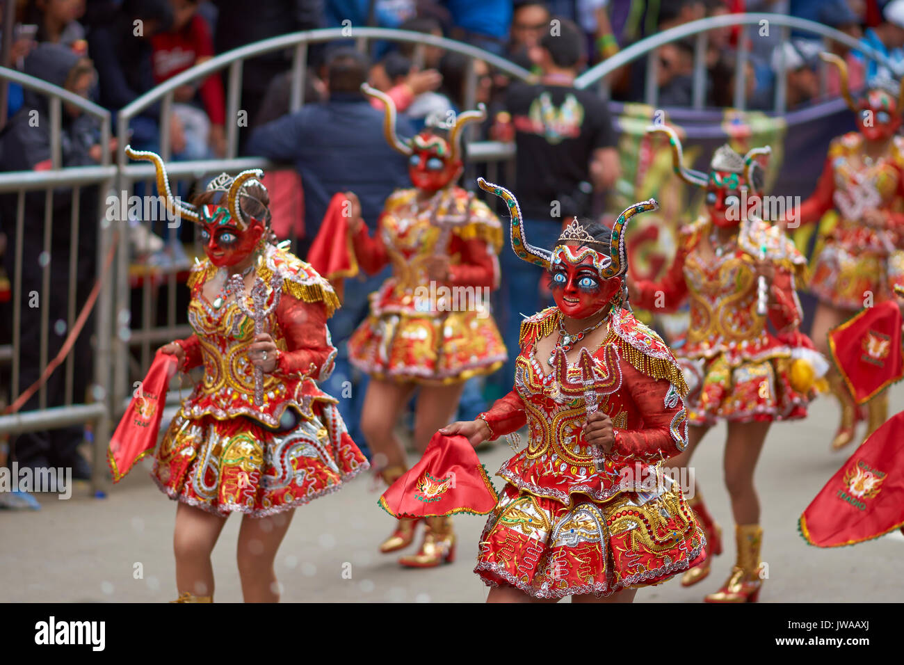 Masked Diablada dancers in ornate costumes parade through the mining ...