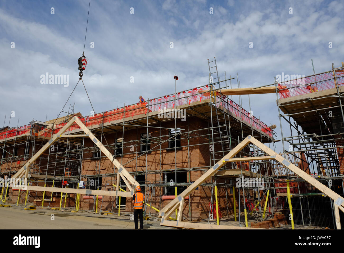 Crane lifting a roof A frame on a new housing estate, Grantham. Lincs ...