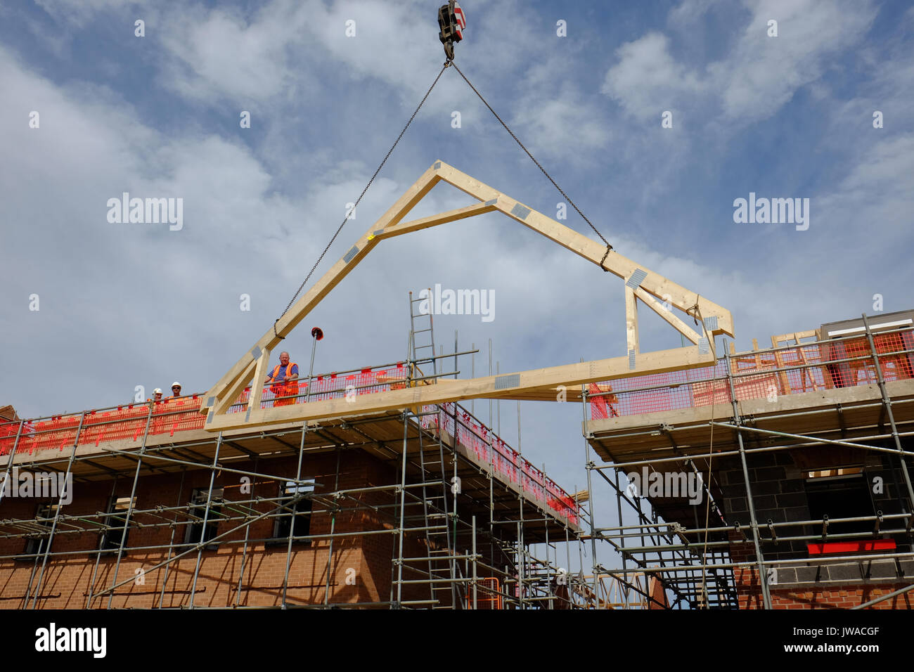 Crane lifting a roof A frame on a new housing estate, Grantham. Lincs ...