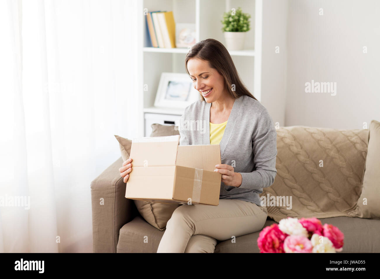 Woman opening cardboard box hi-res stock photography and images - Alamy