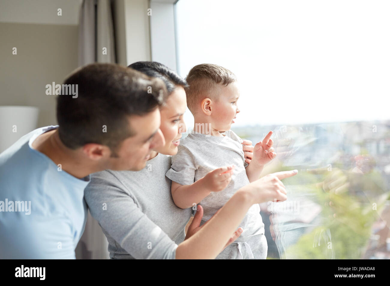 happy family looking through window at home Stock Photo - Alamy