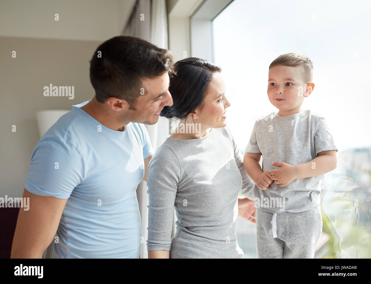 happy family at window Stock Photo - Alamy