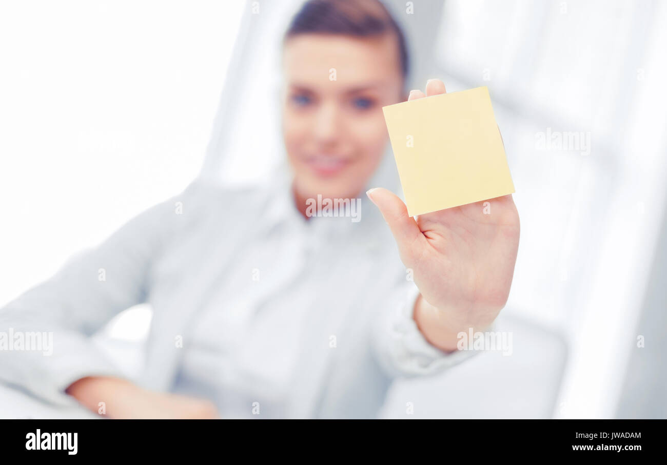smiling businesswoman showing sticky note Stock Photo - Alamy