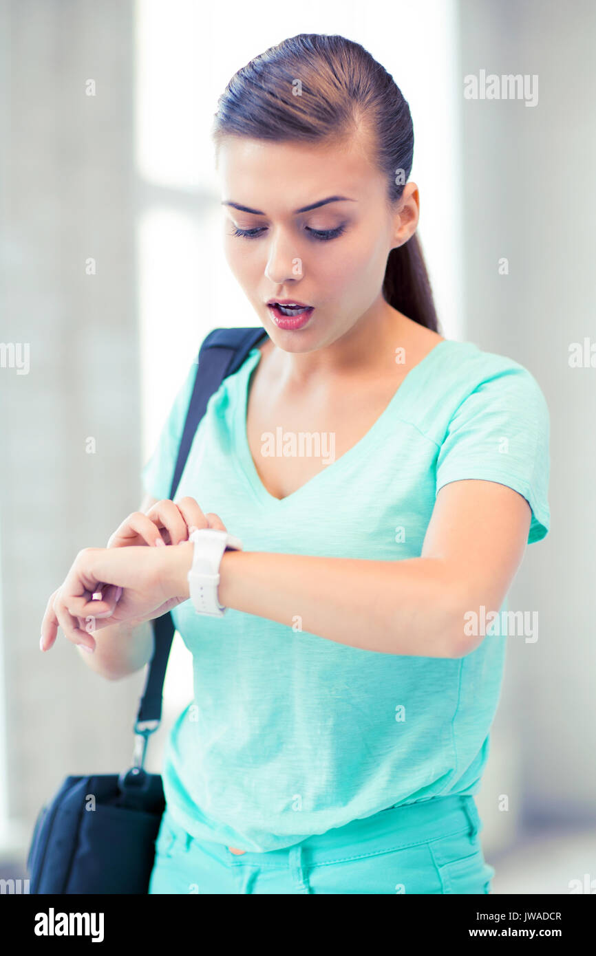 surprised student girl looking at clock Stock Photo - Alamy