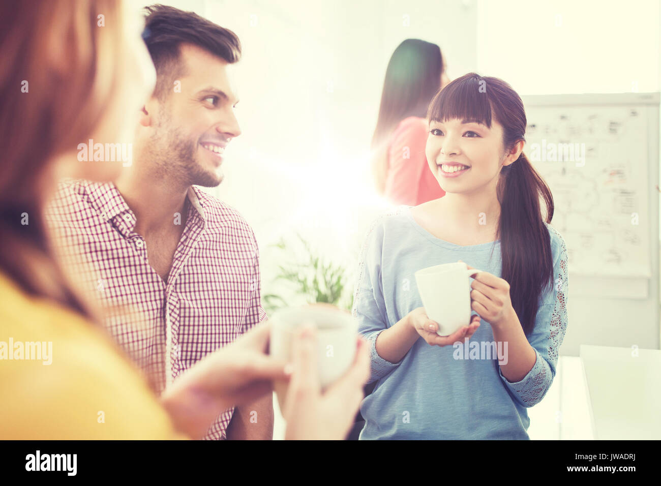happy creative team drinking coffee at office Stock Photo - Alamy