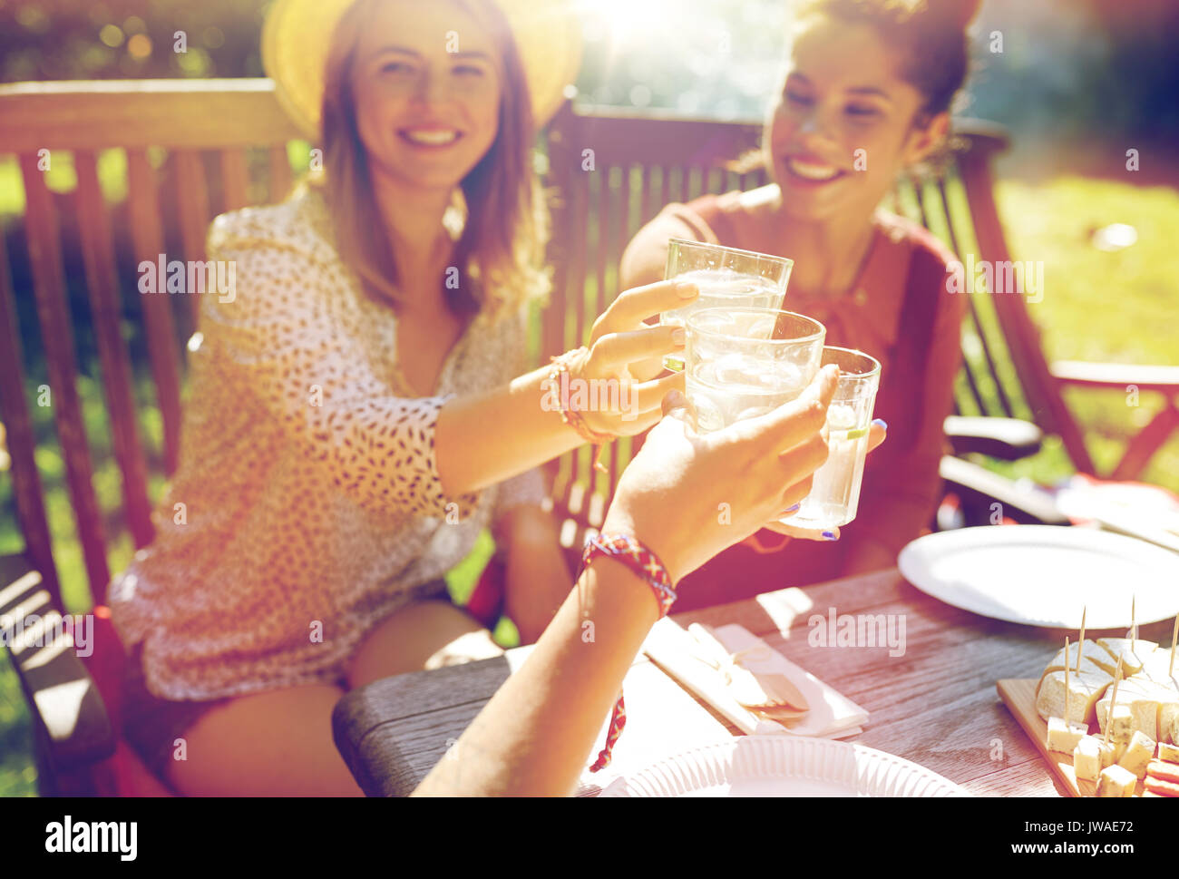 happy friends with drinks at summer garden party Stock Photo - Alamy