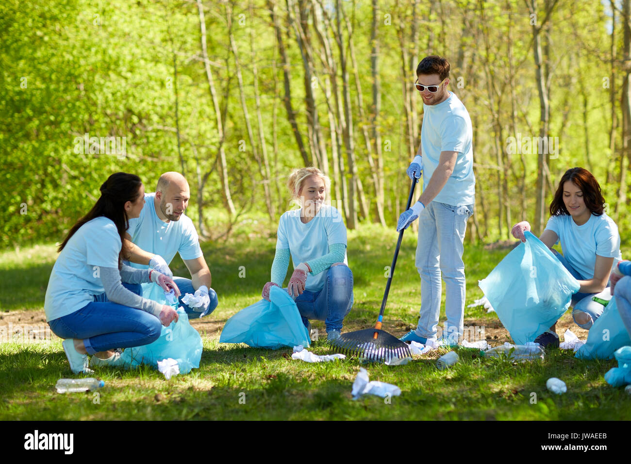 volunteers with garbage bags cleaning park area Stock Photo - Alamy