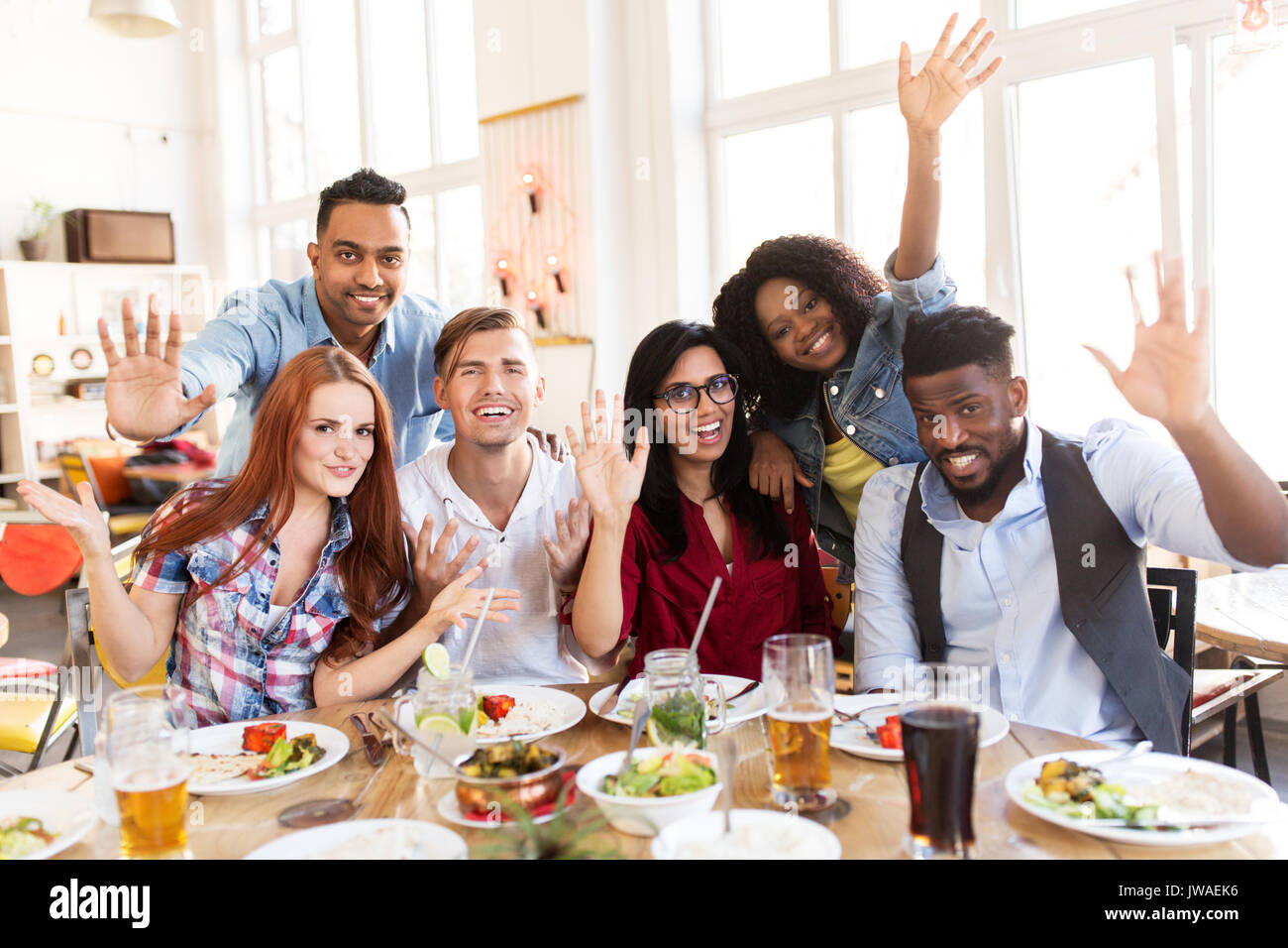 happy friends eating at restaurant Stock Photo - Alamy