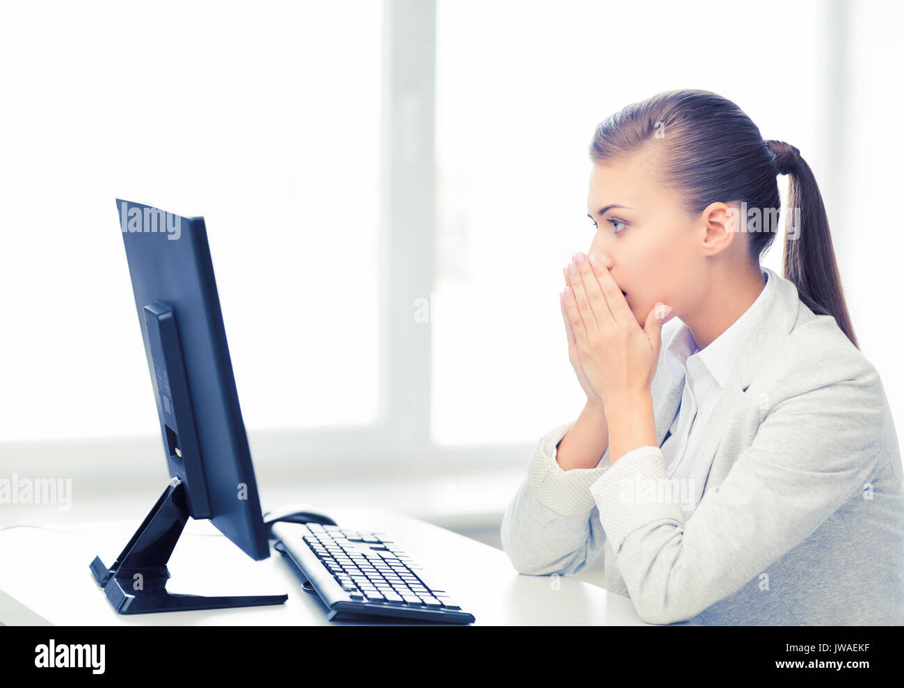 stressed student with computer in office Stock Photo - Alamy
