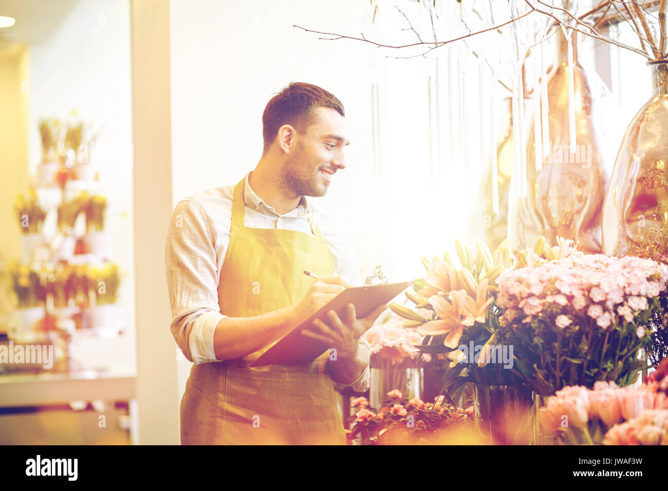 florist man with clipboard at flower shop Stock Photo - Alamy