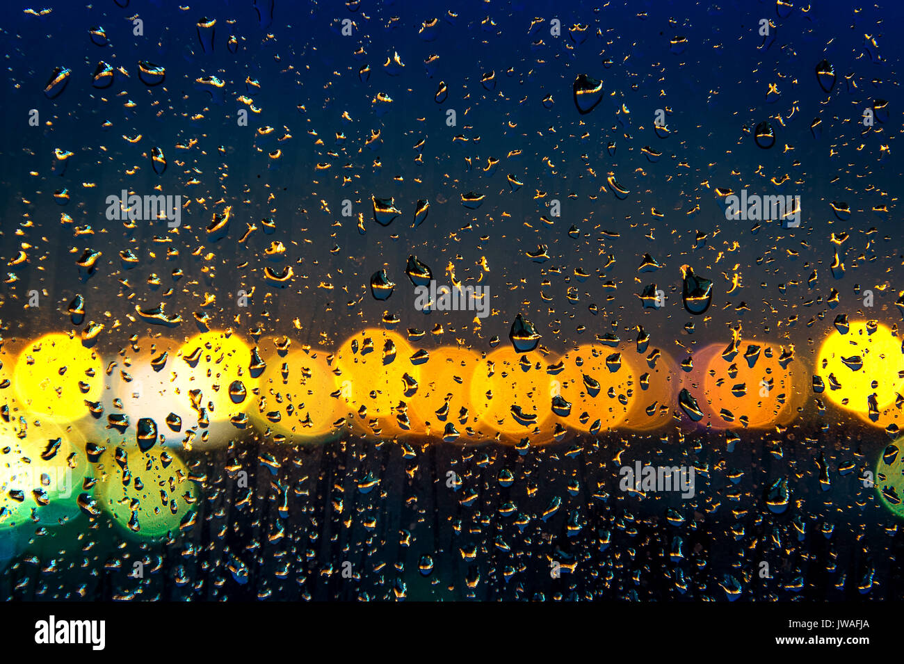 raindrops on window with bokeh of light Stock Photo - Alamy