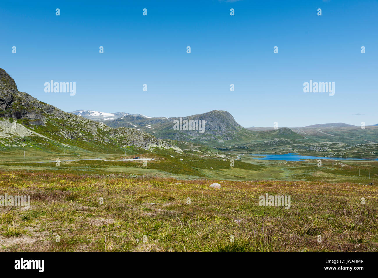 background of green hills and mountains in norway with blue sky ...