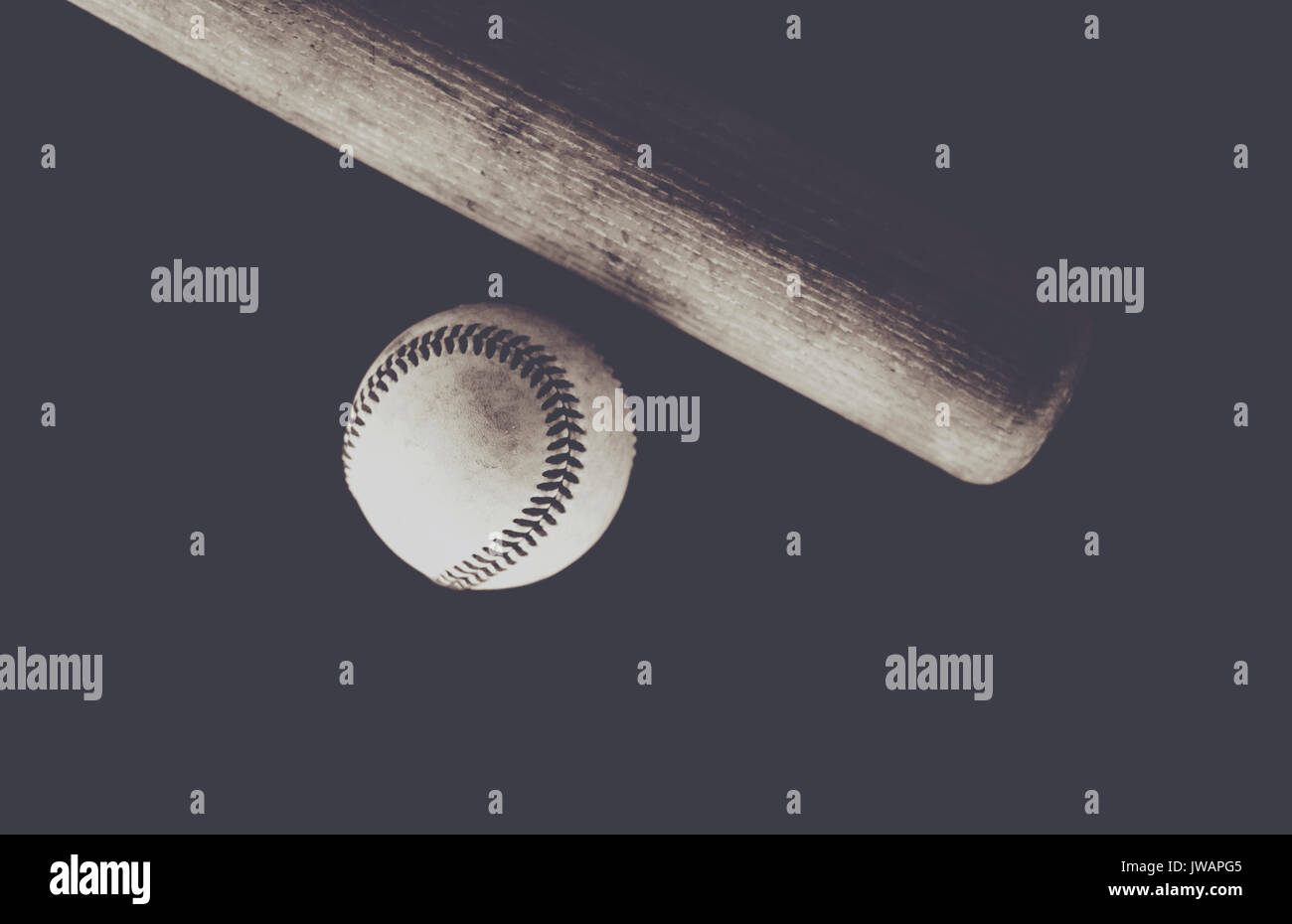 Vintage baseball bat and ball laying flat on the black background ...