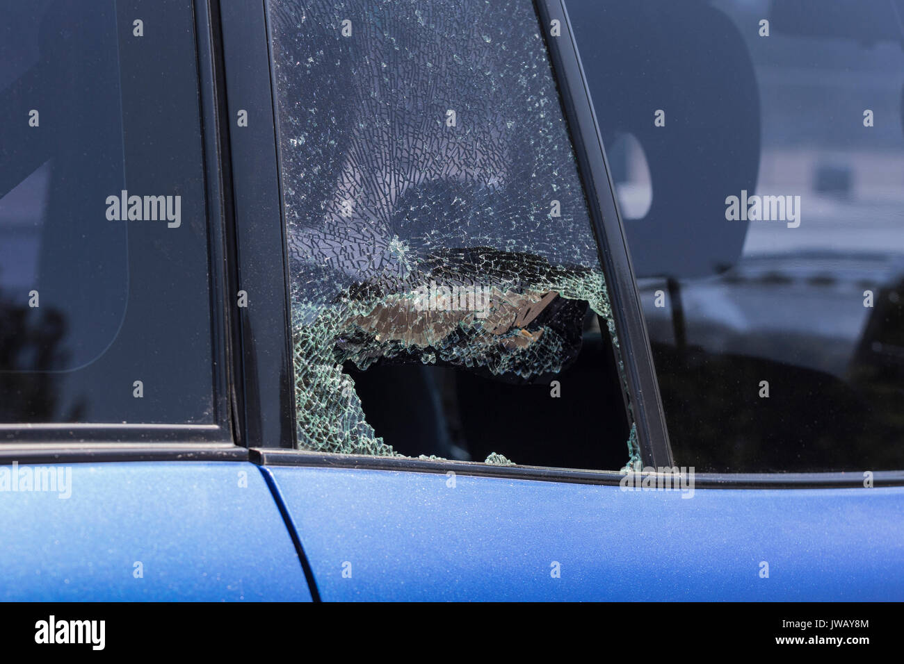 Smashed auto door window from vehicle burglary Stock Photo - Alamy