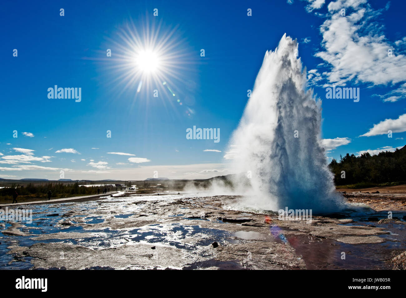 Back lit of Stokkur geyser with sunburst. Strokkur is a fountain geyser ...
