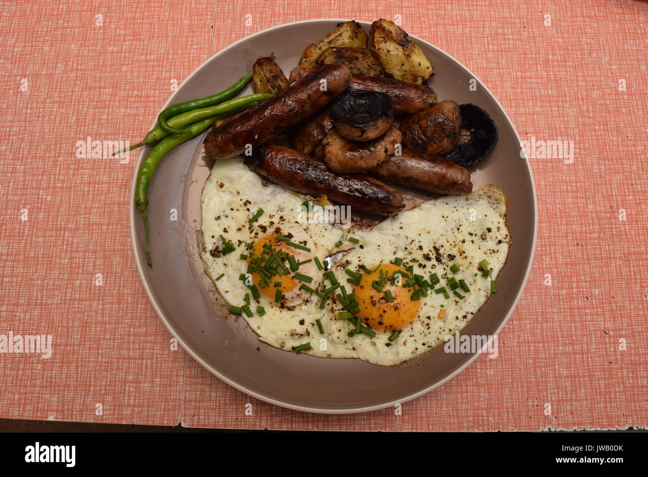 Full english breakfast with two eggs and a sausage hi-res stock ...