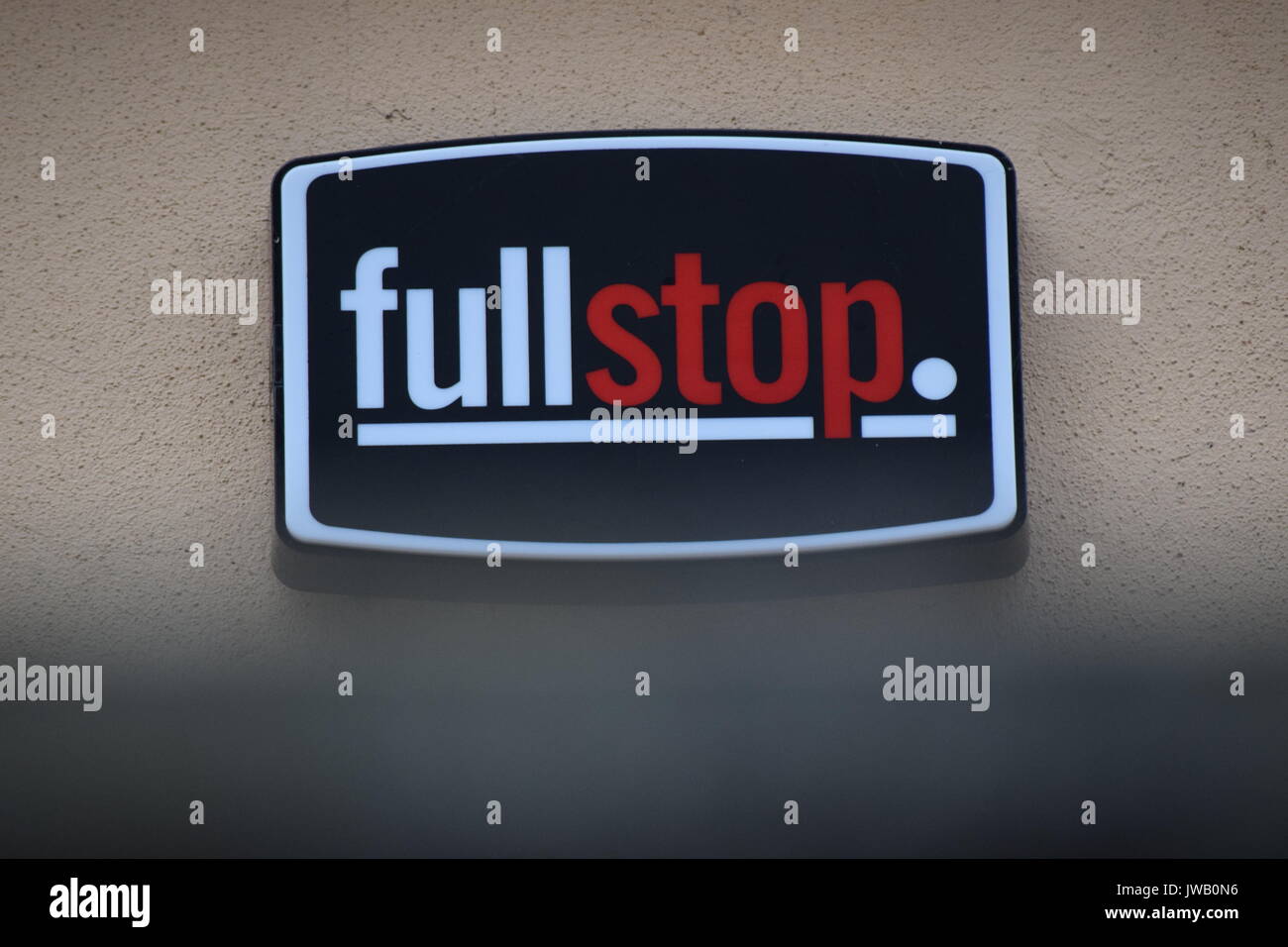 Full stop company sign on a wall Stock Photo - Alamy