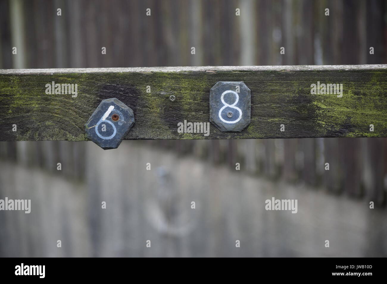 Door number on a fence Stock Photo - Alamy