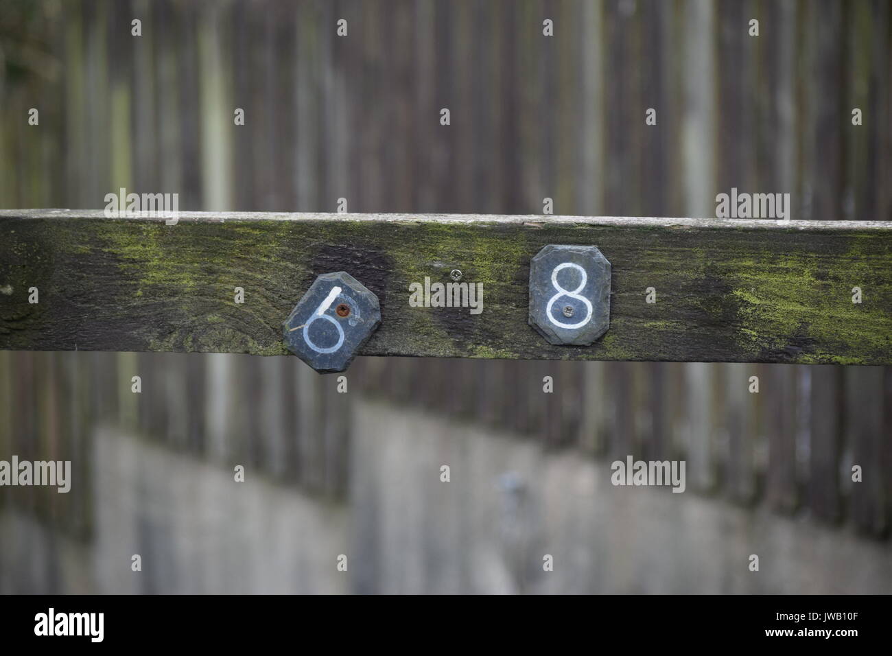 Door number on a fence Stock Photo - Alamy