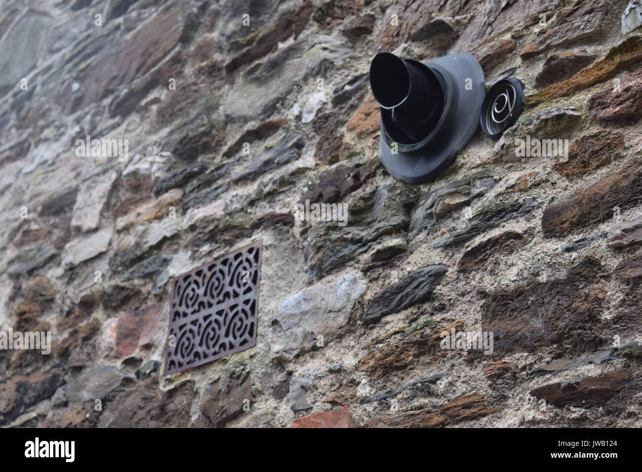Narrow alleyway with outdoor ventilation with pipes Stock Photo - Alamy