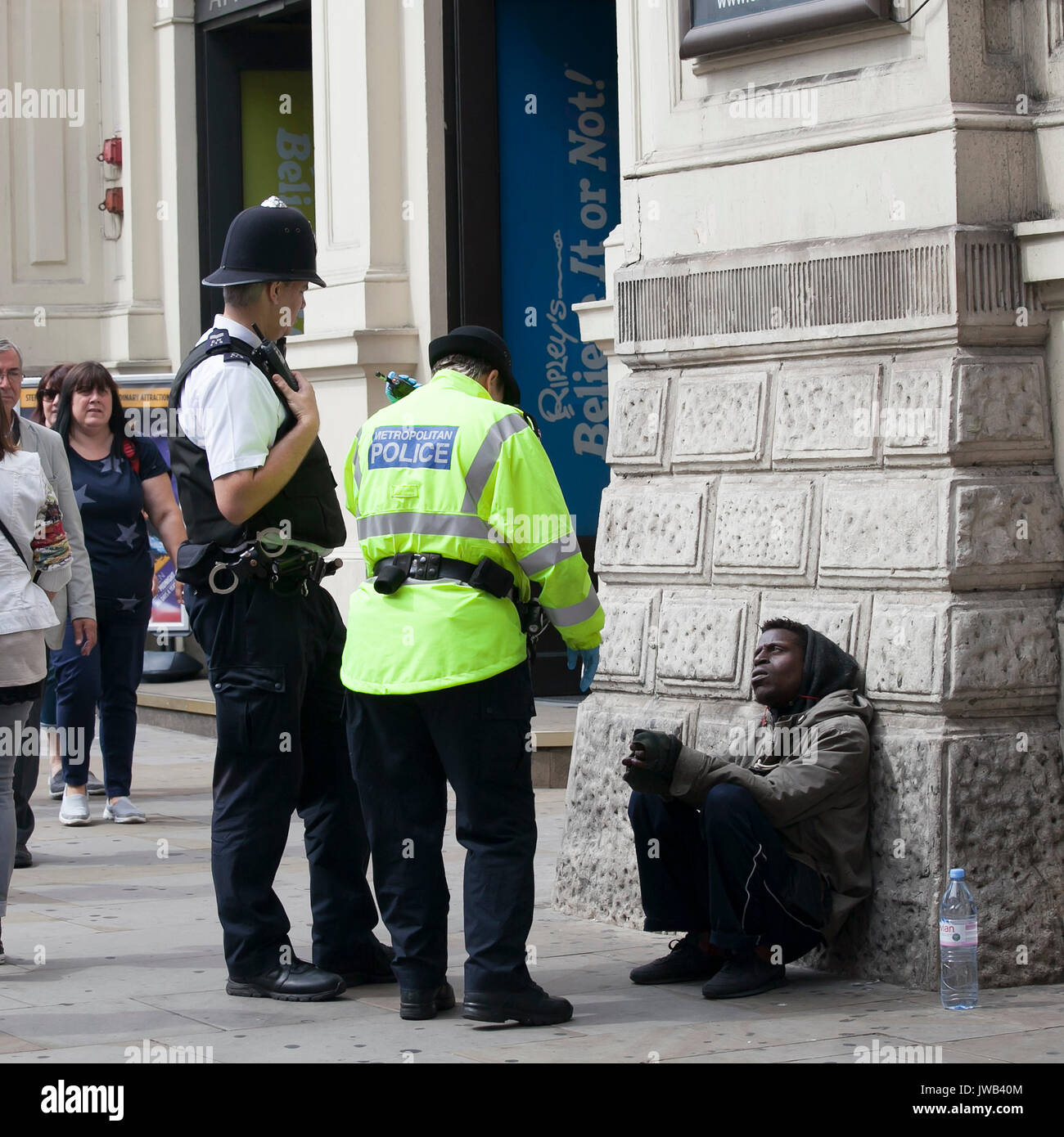 LONDON, ENGLAND - August 11 2017 Police talking to an African American ...