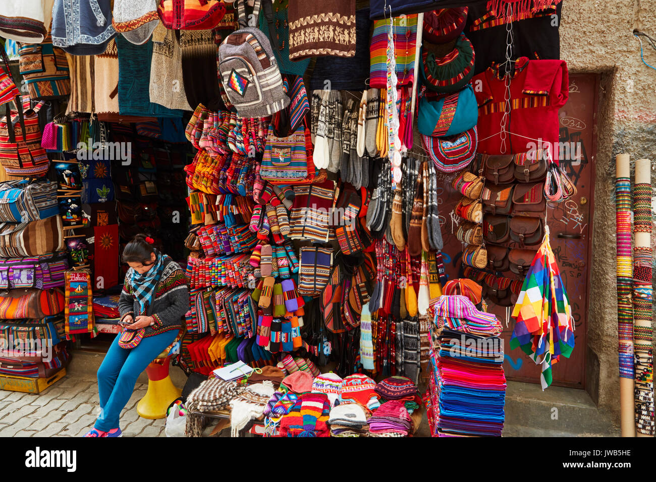 Shopkeeper outside shop selling Bolivian handicrafts, Witches Market ...