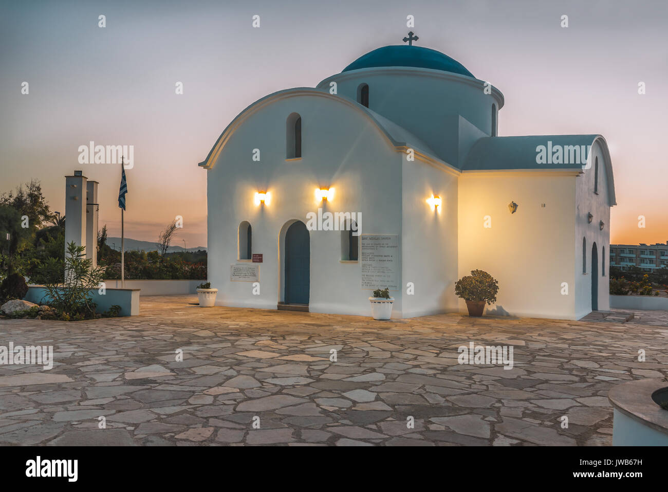 A small white church on the beach in Paphos, Cyprus during the dawn ...