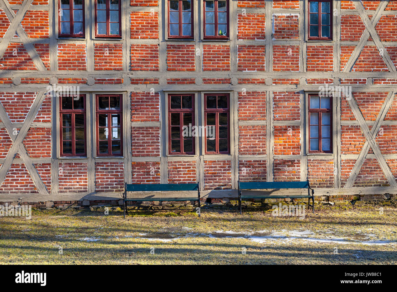 Brick wall texture background on day noon light with windows and benhes ...