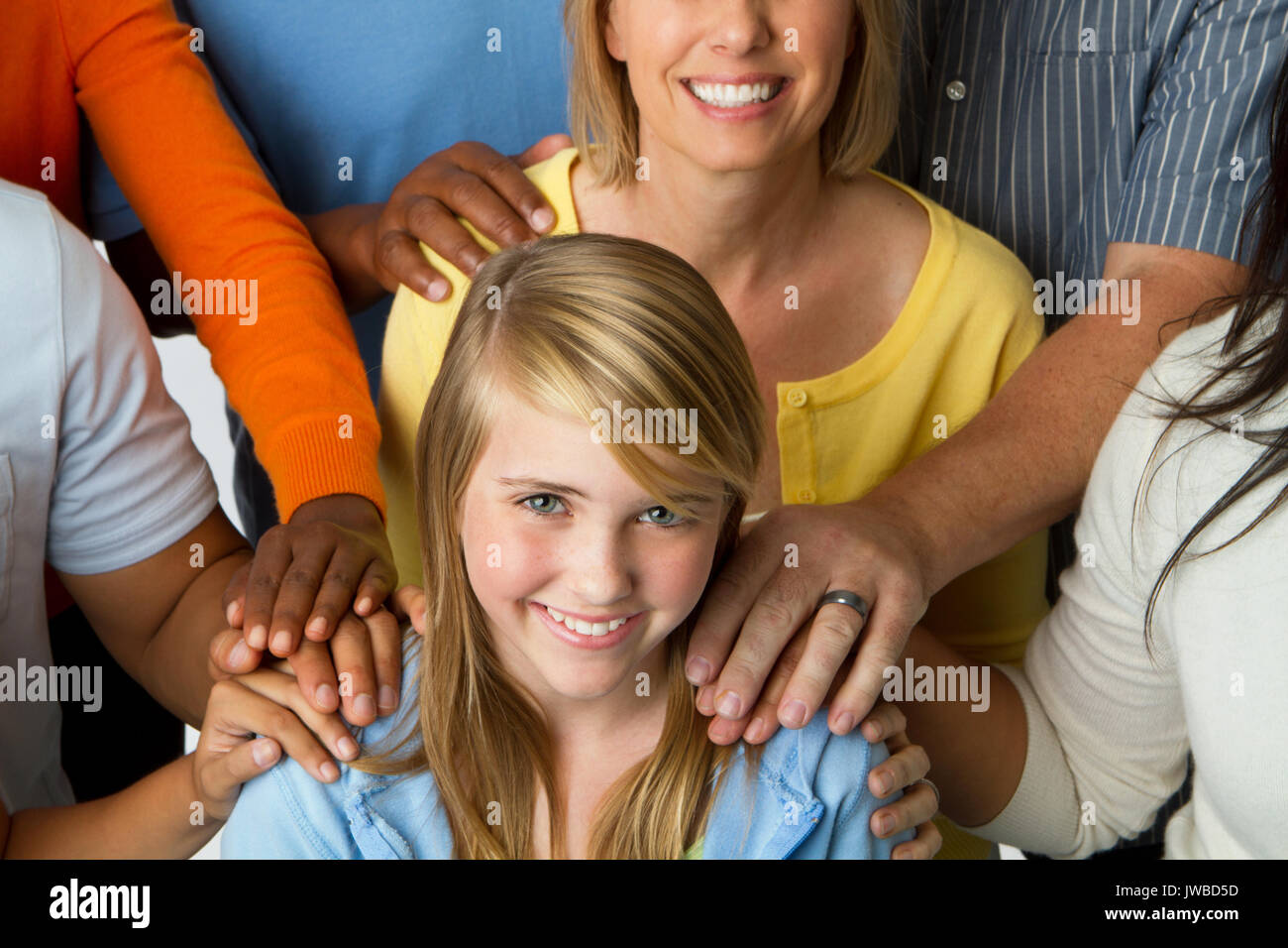 Diverse community of people praying for a young girl Stock Photo - Alamy