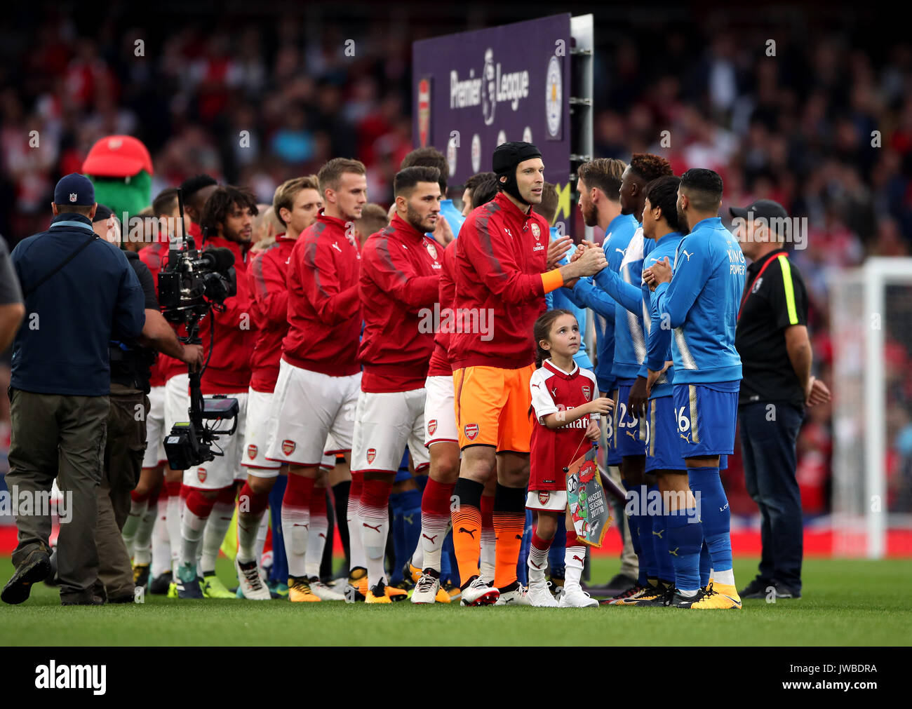 Arsenal goalkeeper Petr Cech leads his team shaking hands with the ...