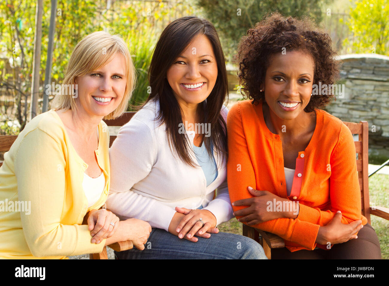 Diverse group of friends talking and laughing Stock Photo - Alamy