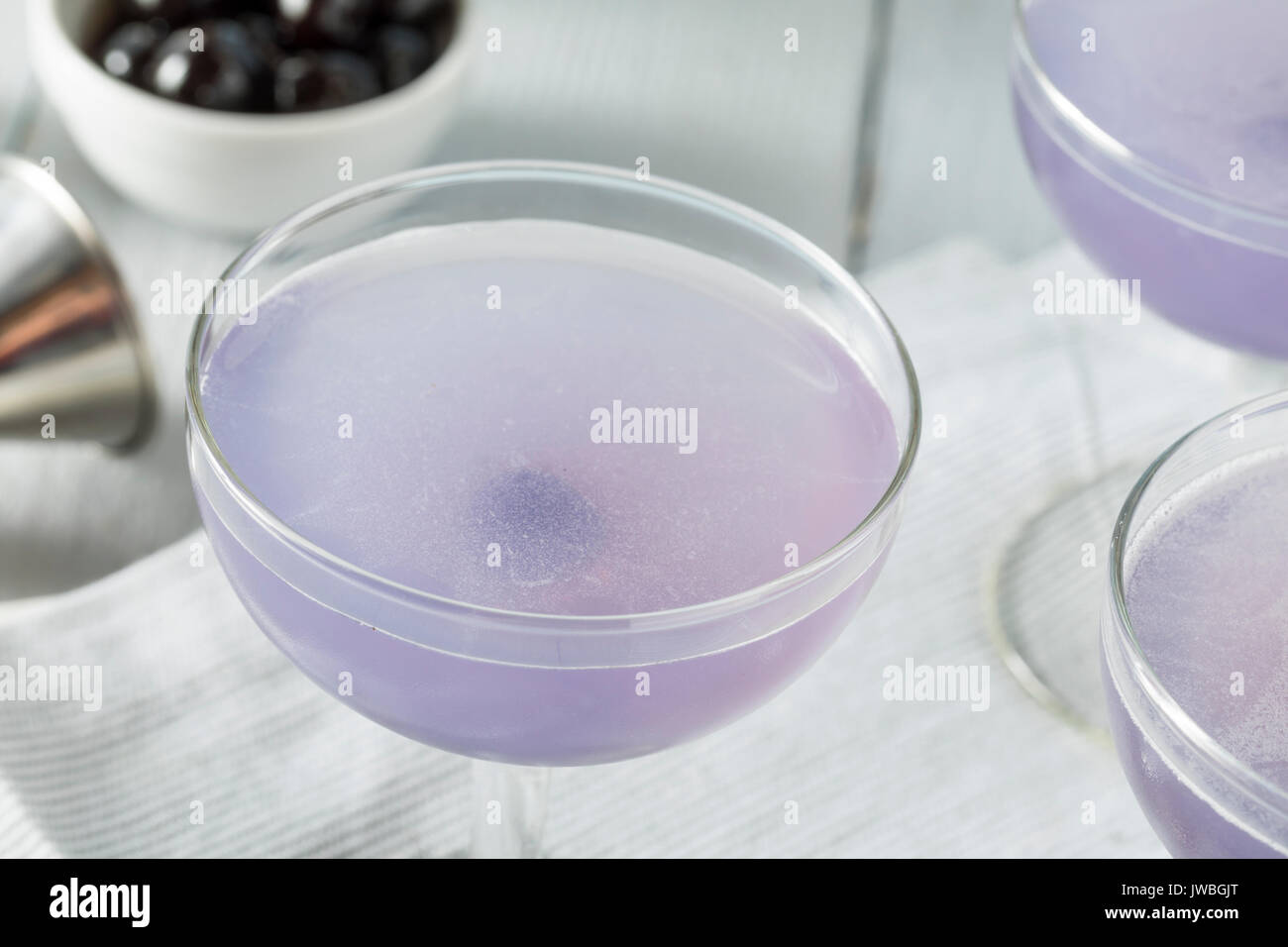 Sweet Violet Aviation Cocktail with a Cherry Garnish Stock Photo - Alamy