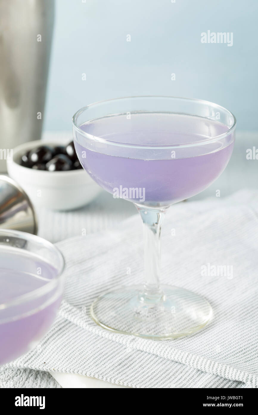 Sweet Violet Aviation Cocktail with a Cherry Garnish Stock Photo - Alamy