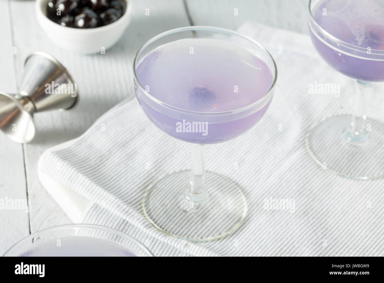 Sweet Violet Aviation Cocktail with a Cherry Garnish Stock Photo - Alamy