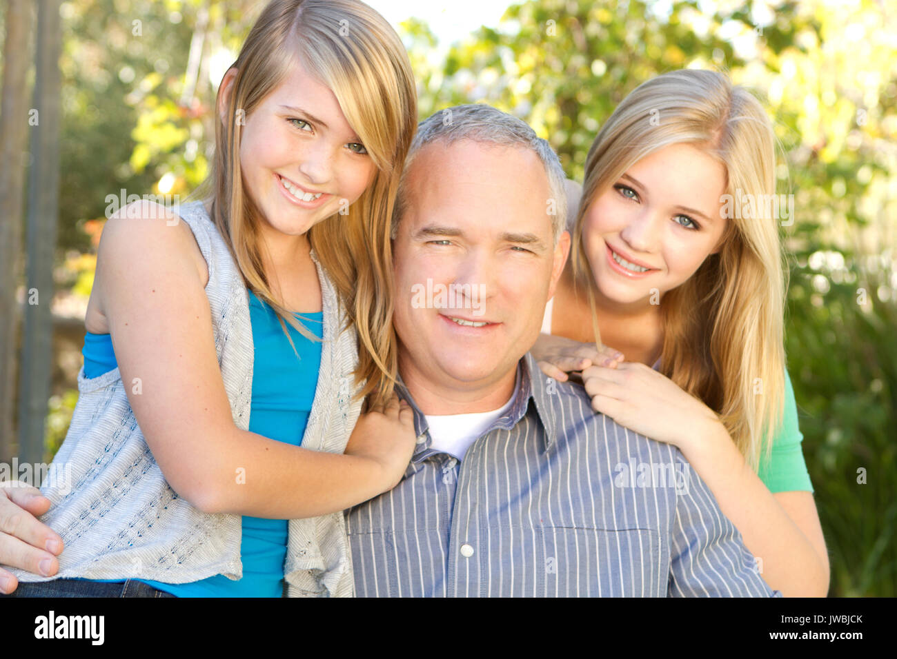 Happy family smiling Stock Photo - Alamy