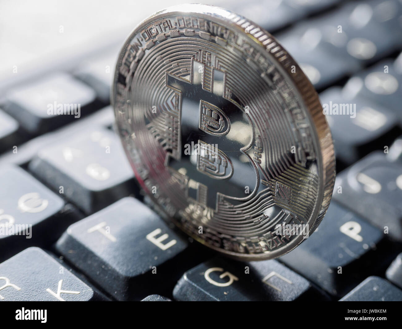 Digital currency physical metal bitcoin coin on the keyboard Stock ...