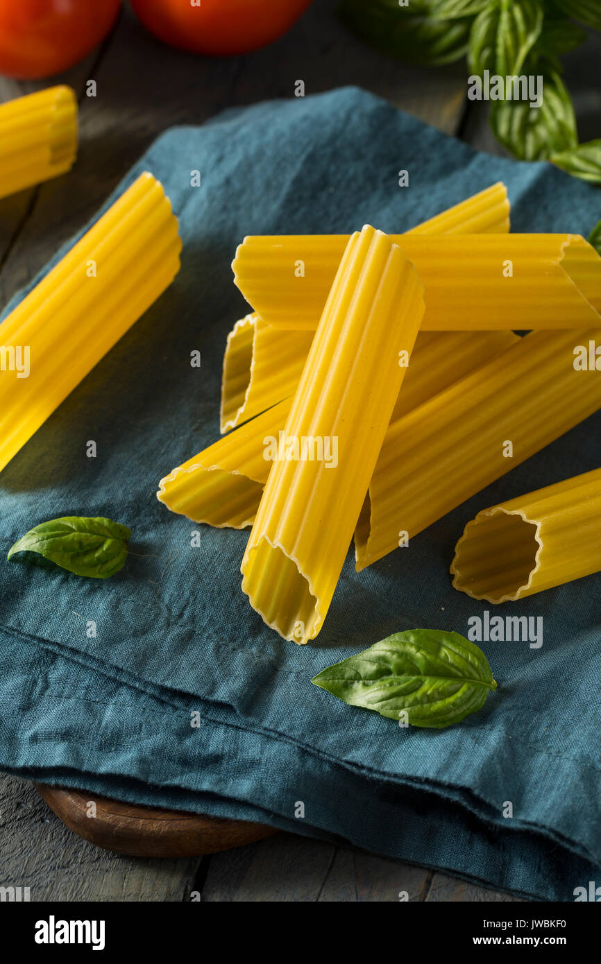 Dry Organic Manicotti Pasta Tube with Basil and Tomato Stock Photo - Alamy