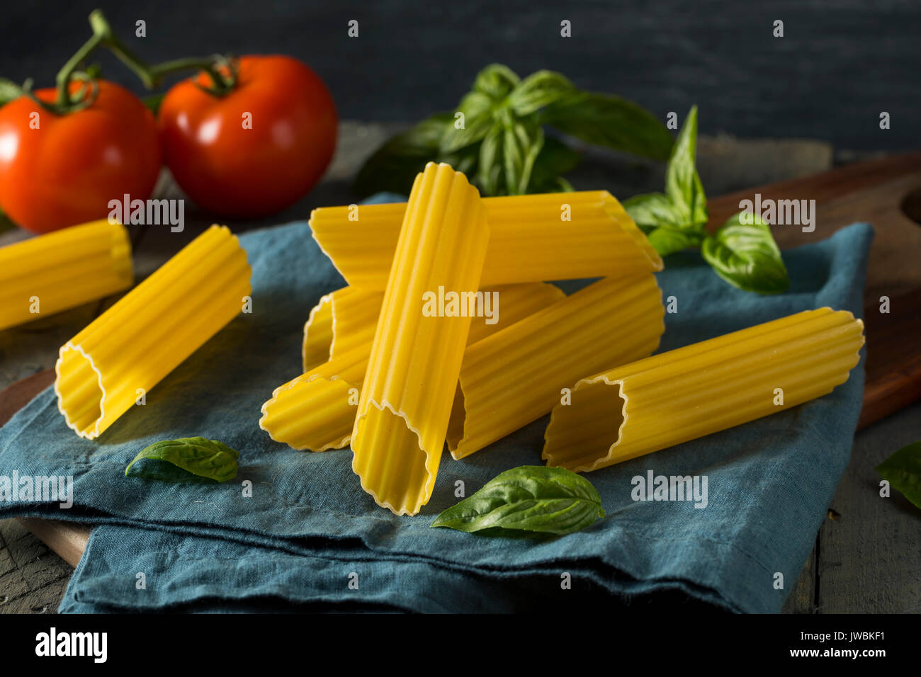 Dry Organic Manicotti Pasta Tube with Basil and Tomato Stock Photo - Alamy