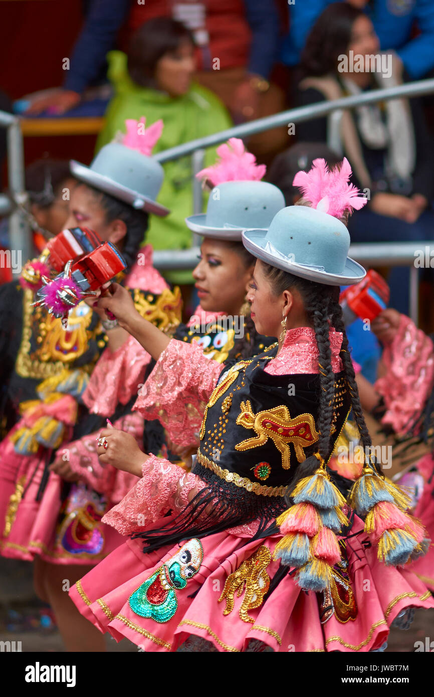 Morenada dance group in colourful outfits parading through the mining ...
