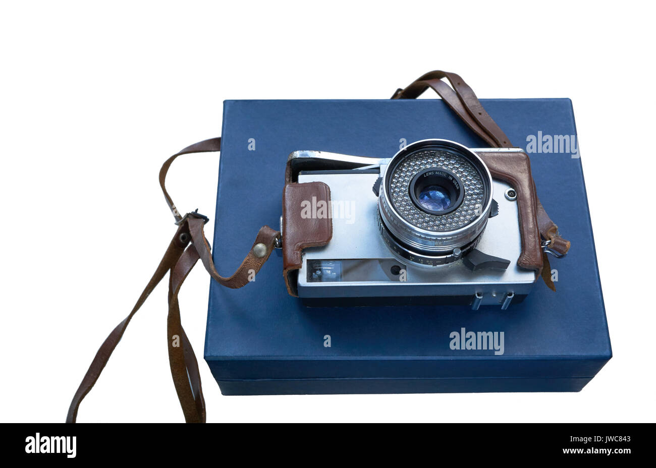 vintage film photo camera in leather case on a blue box isolated cutout ...