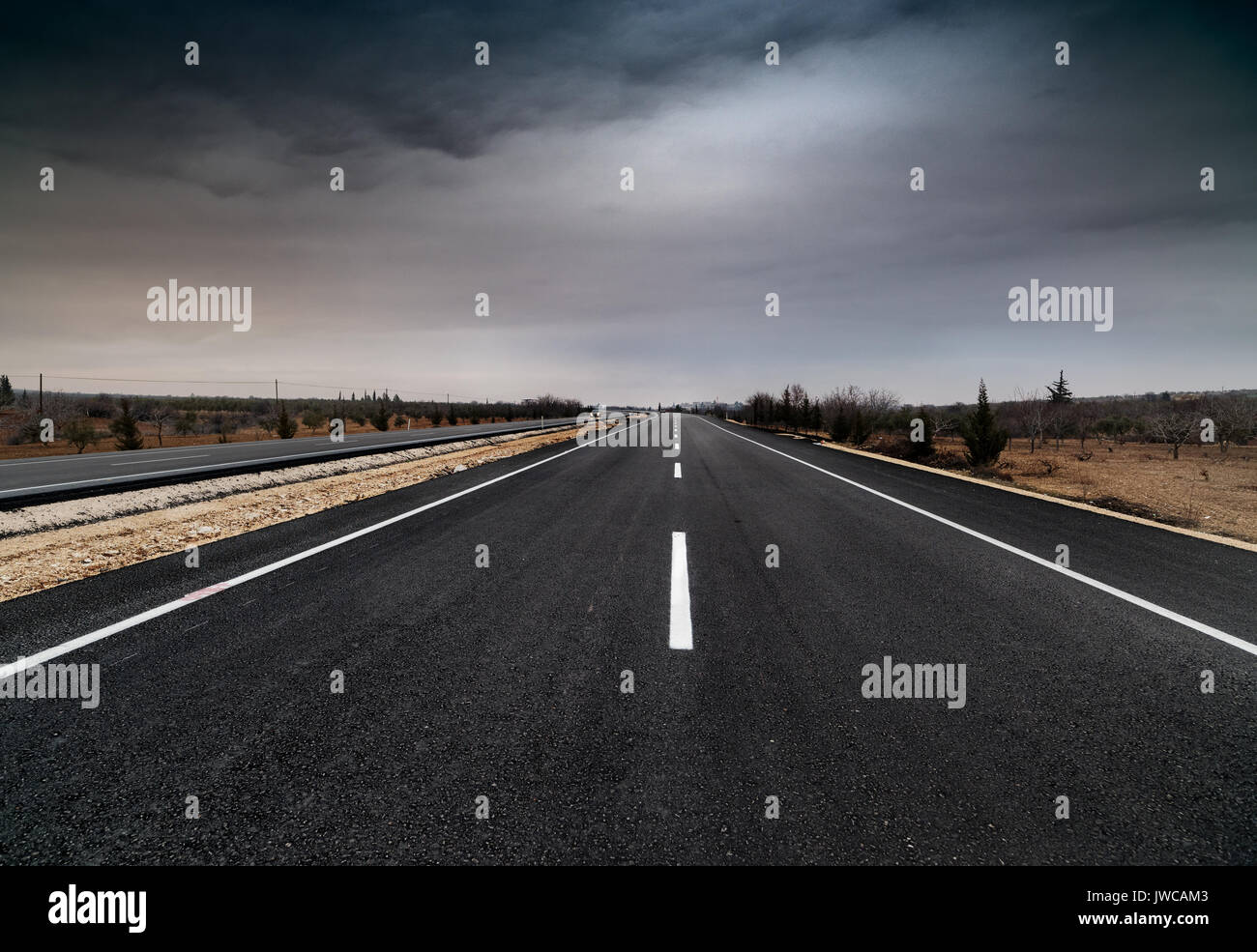 Asphalt road before rain Stock Photo - Alamy