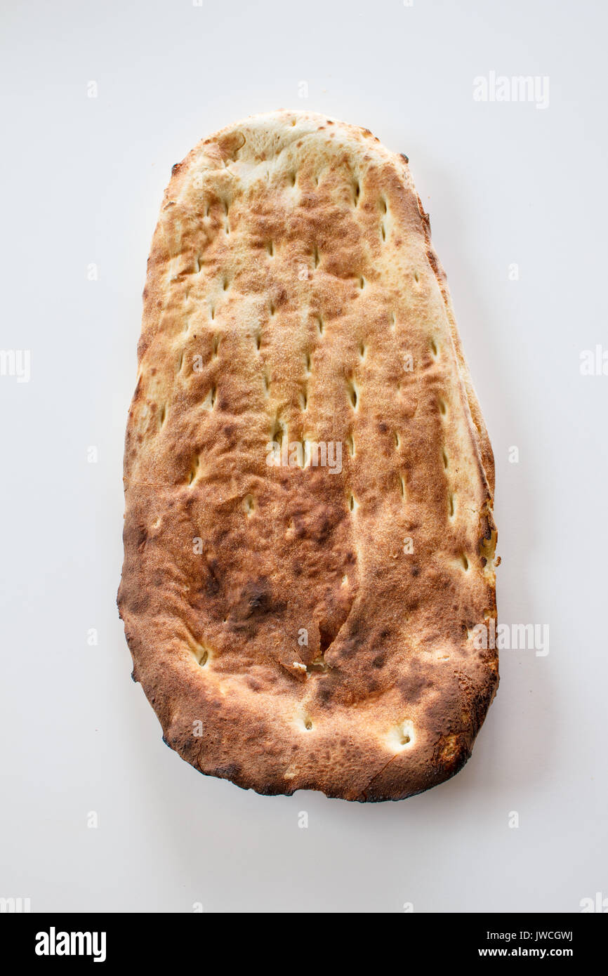single piece of naan on white background Stock Photo - Alamy