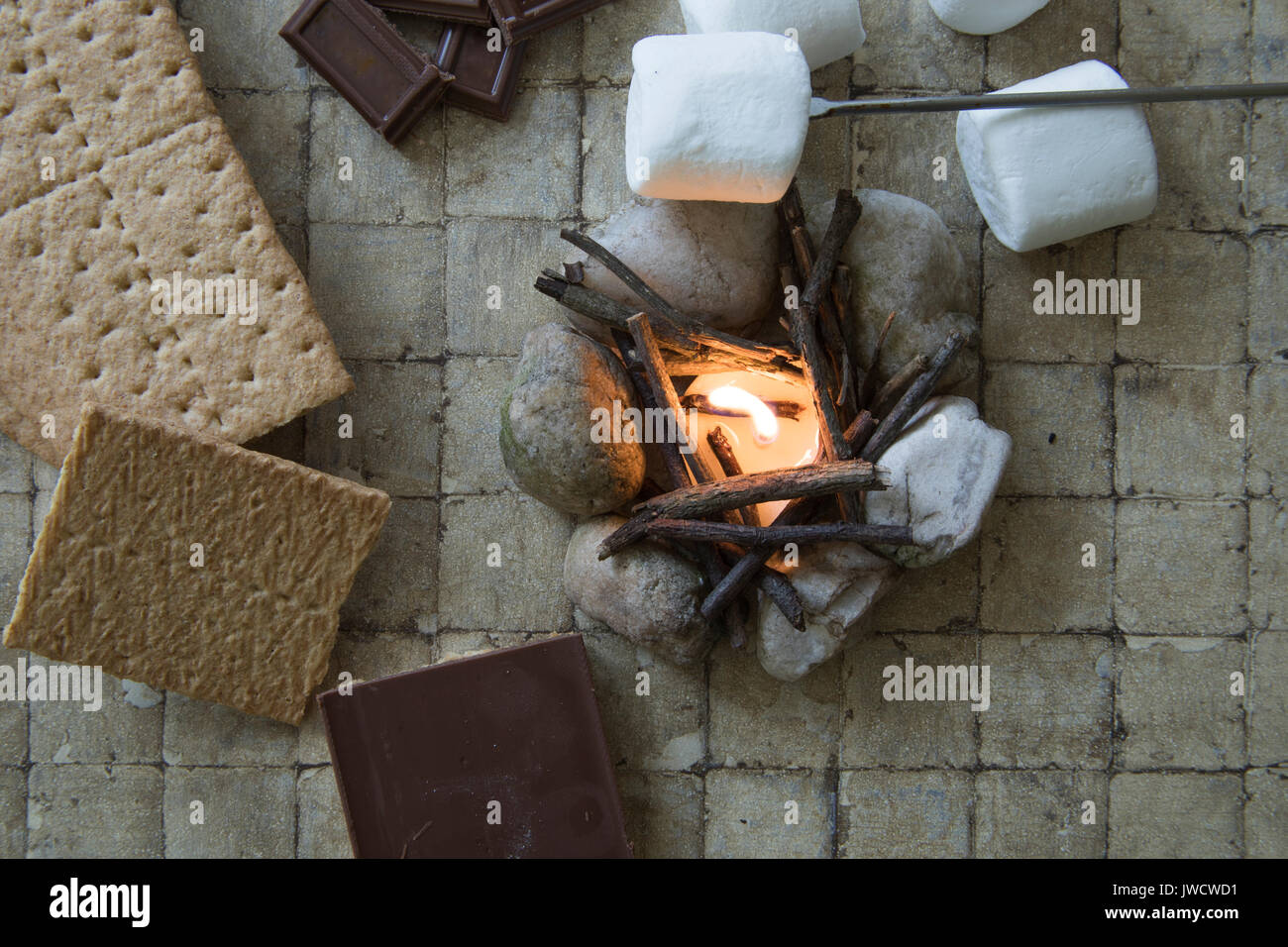 Components of s'more treats including chocolate bar, graham crackers ...