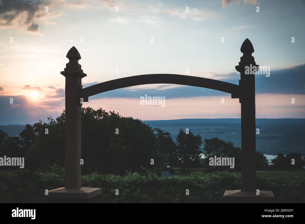 Colorful sunrise over ceremonial arch at a vinyard along a lake Stock ...