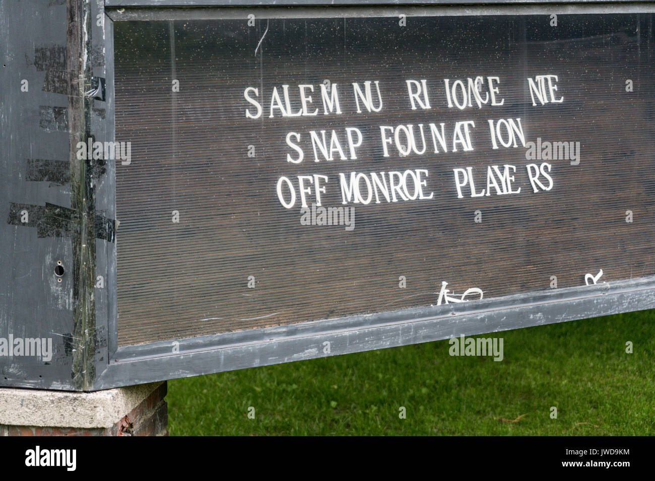 Damaged sign with missing letters in front of a church Stock Photo - Alamy