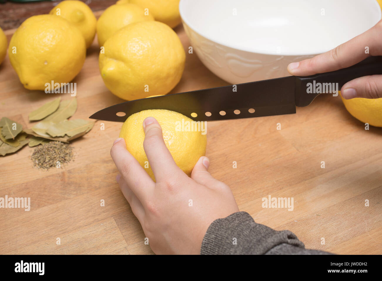 Person making salted preserved lemons, by cutting and spicing Stock ...