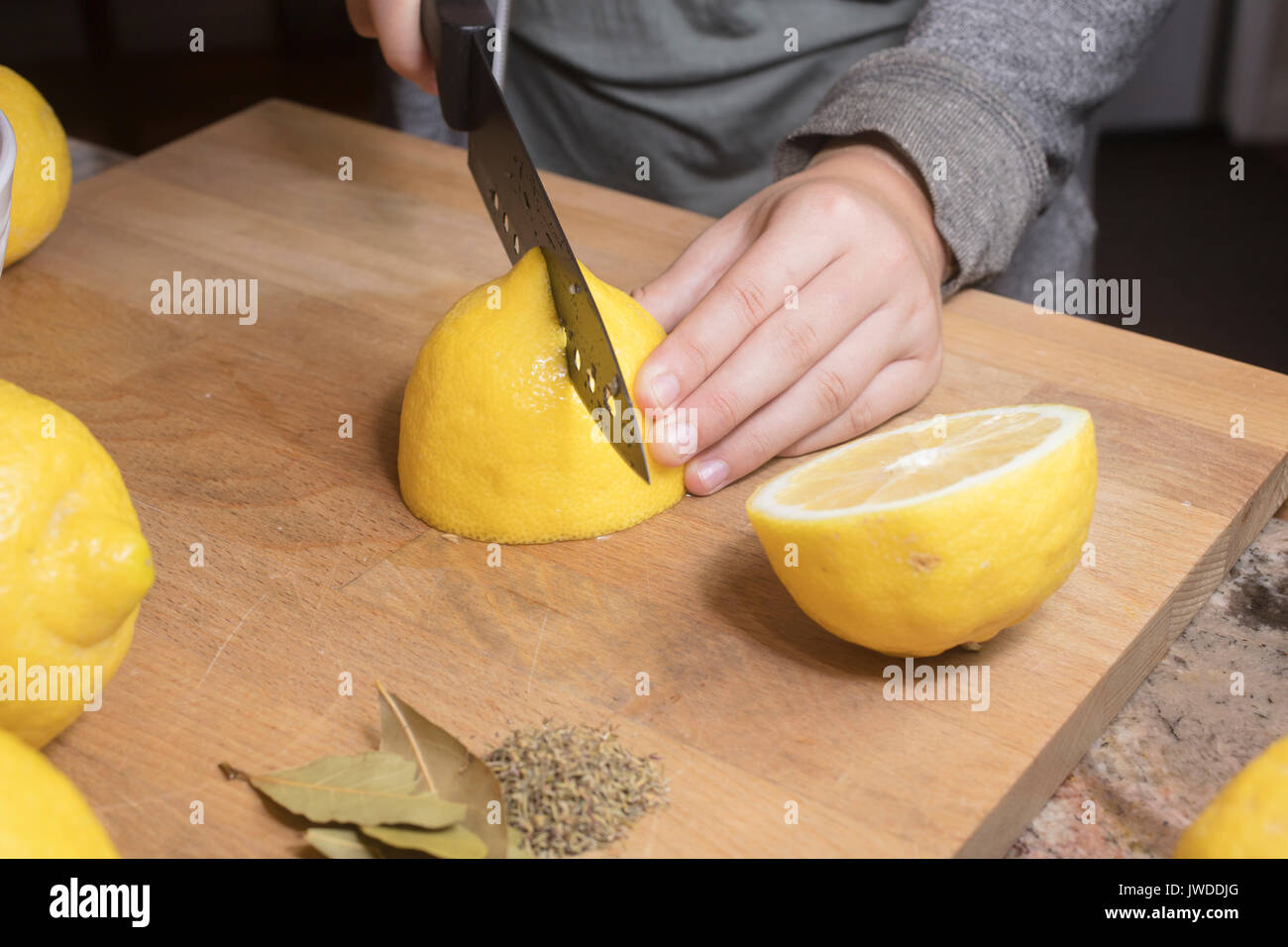 Person making salted preserved lemons, by cutting and spicing Stock ...