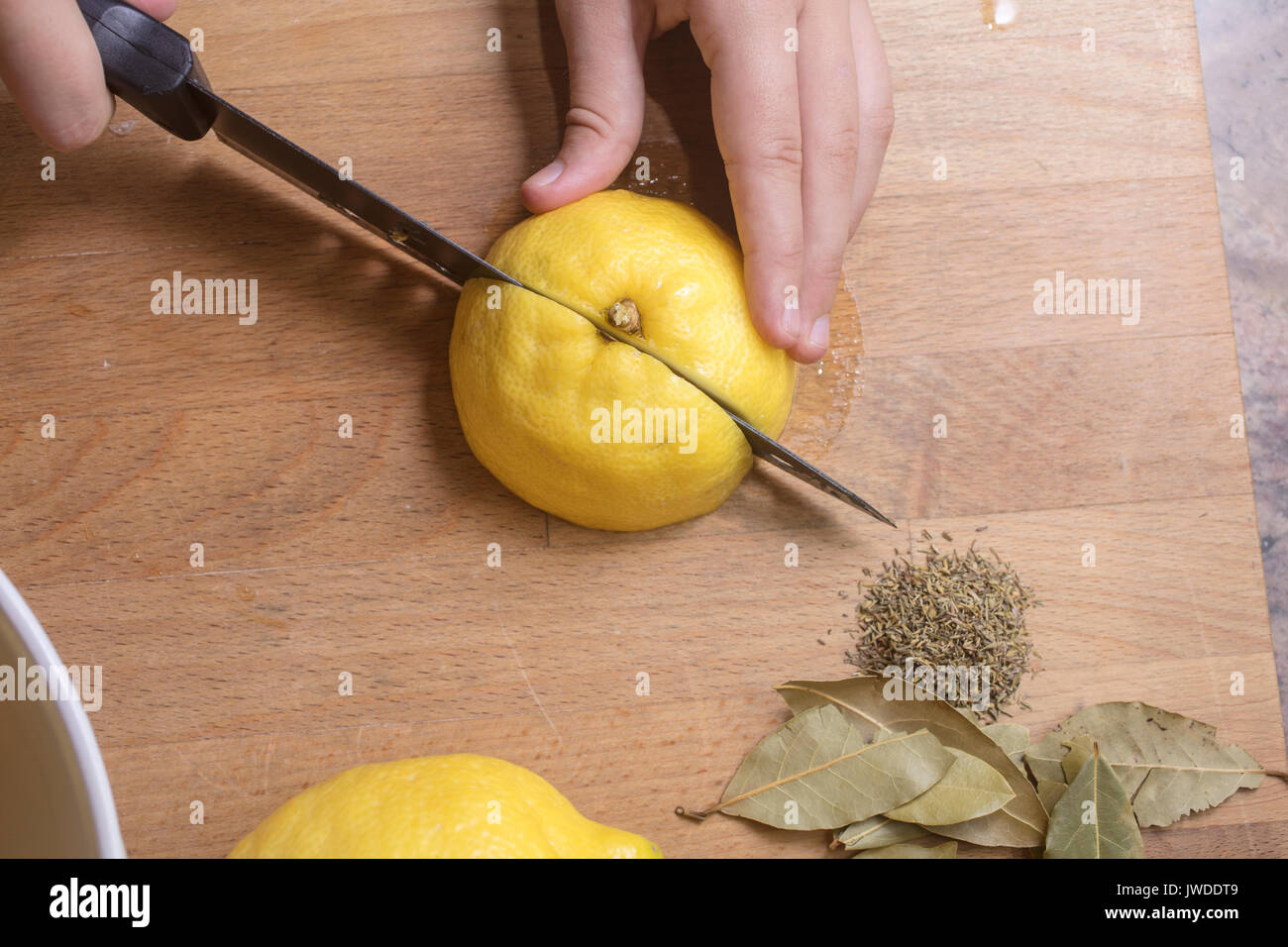 Person making salted preserved lemons, by cutting and spicing Stock ...