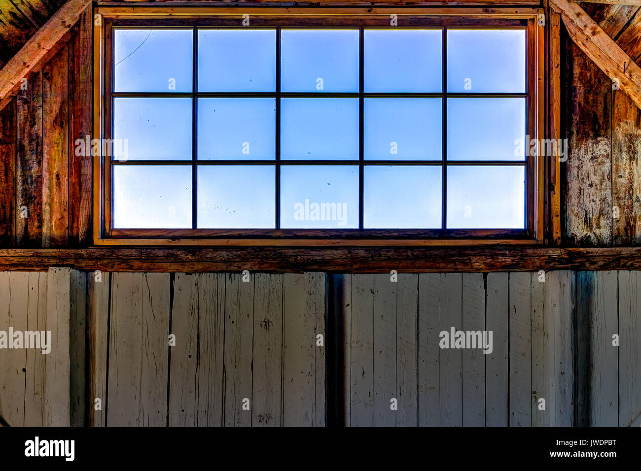 Looking through old rustic window of house with ocean view in ...