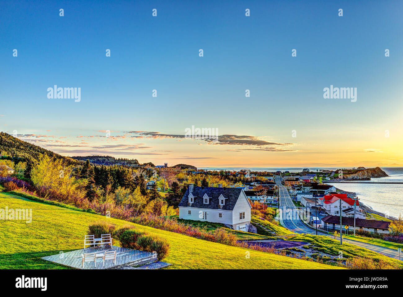 Hotel chairs on hill during sunrise in Perce, Gaspe Peninsula, Quebec ...